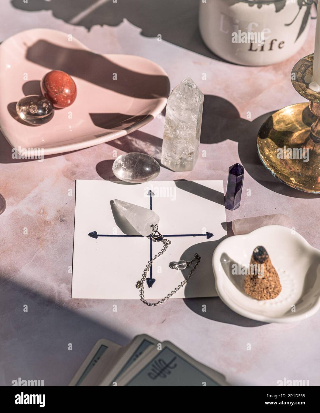 Gemstones for esoteric spiritual practice. Rock crystal pendulum on the ...