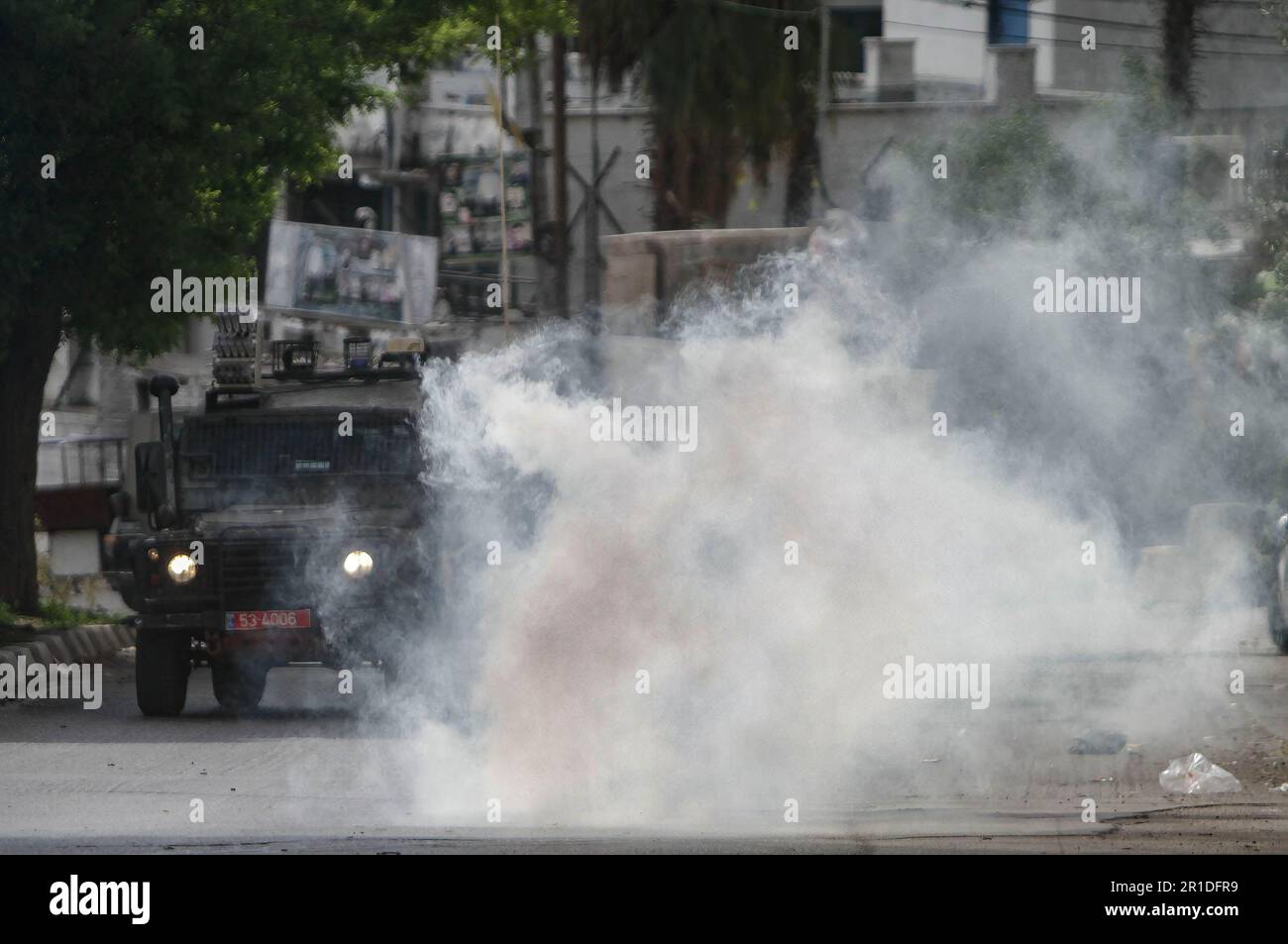 Smoke rises after the explosion of a homemade bomb in front of an ...