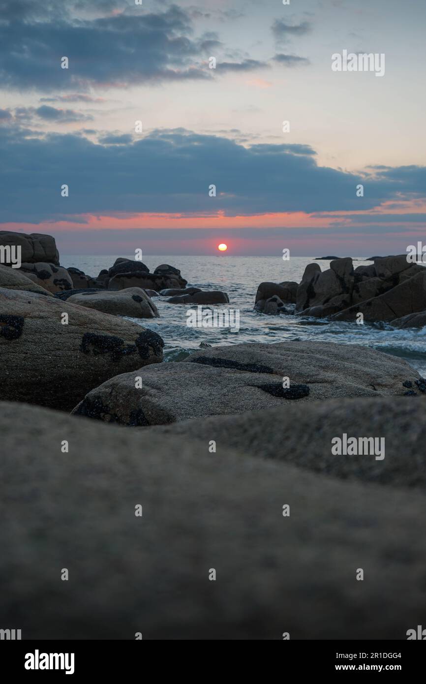 A picturesque beach scene with a stunning sunset backdrop in Brittany ...