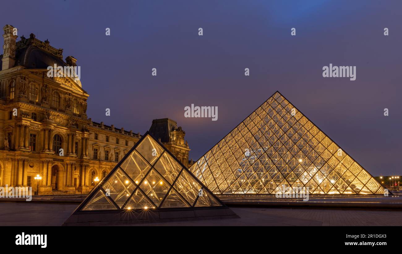 The Louvre in Paris, France. Glass Pyramids at night in the famous ...