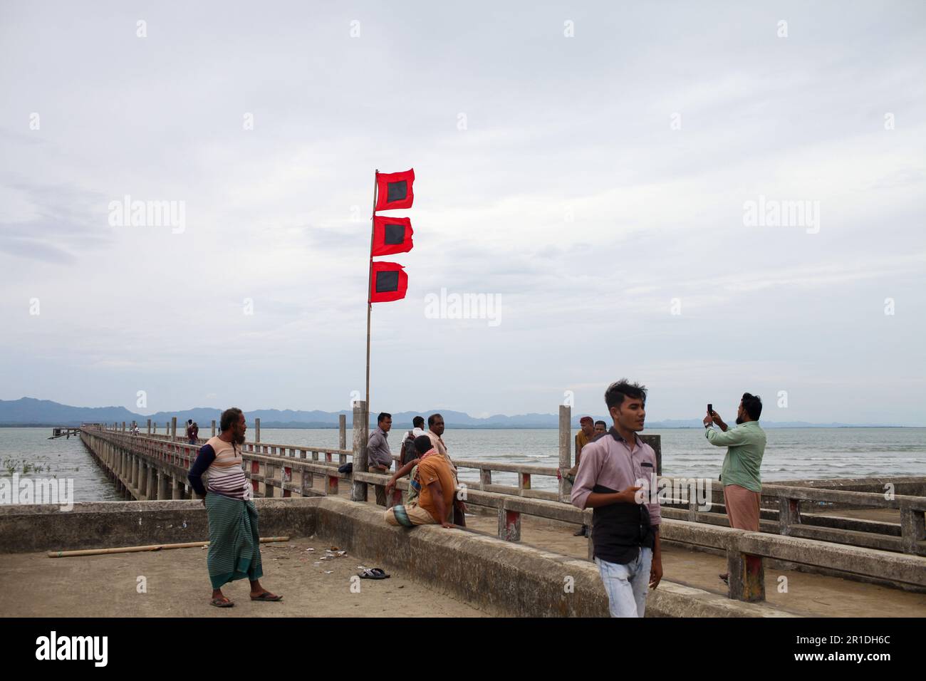 May 13, 2023, Dhaka, Dhaka, Bangladesh: People gather beside a storm ...