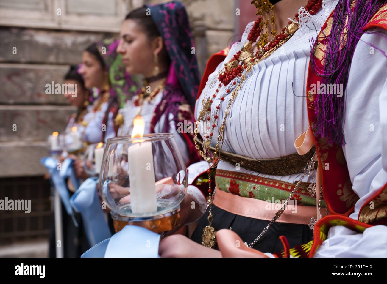Perspective view of a row of girls with candles at the folk/religious ...