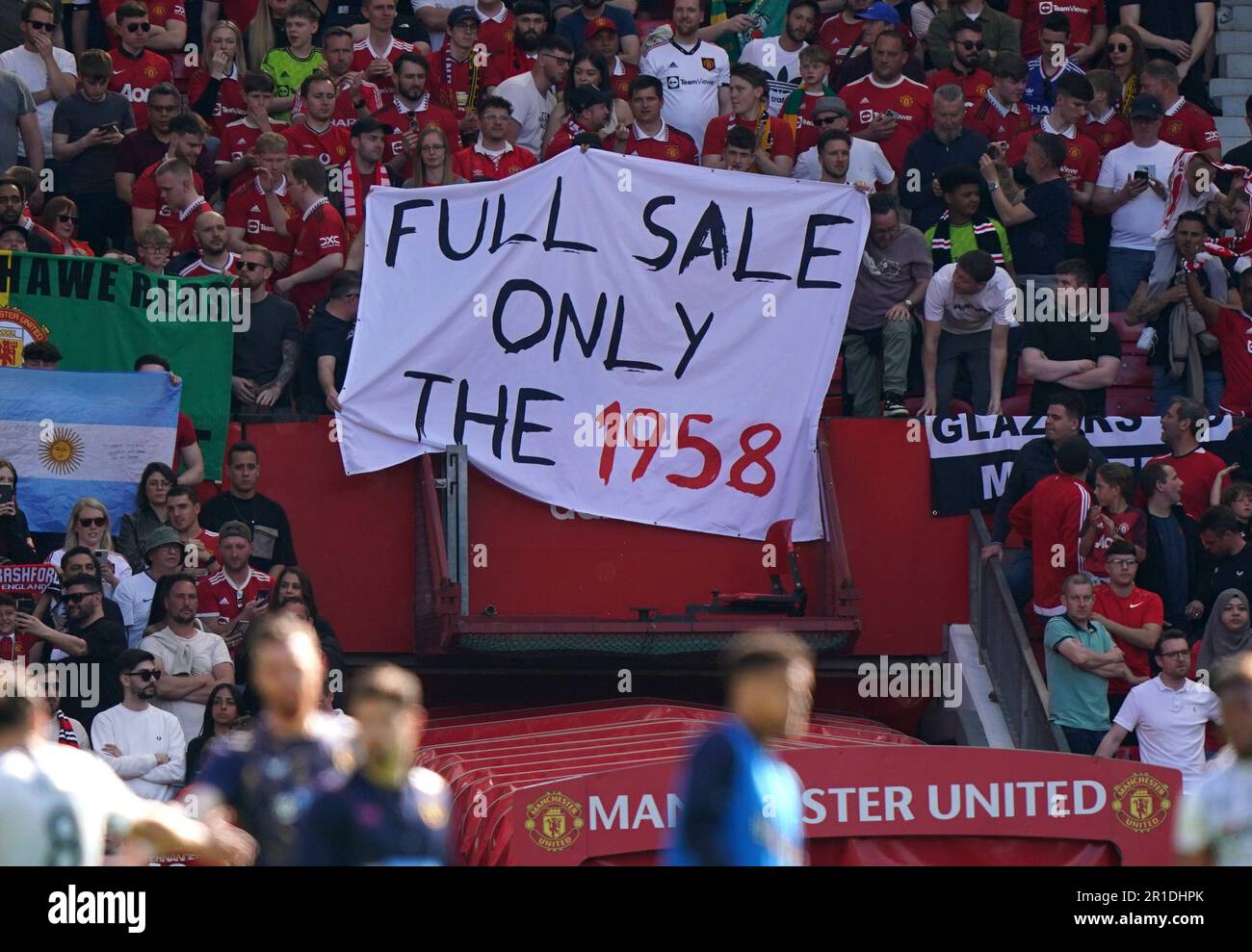 Manchester United fans in the stands hold up a banner protesting the ...
