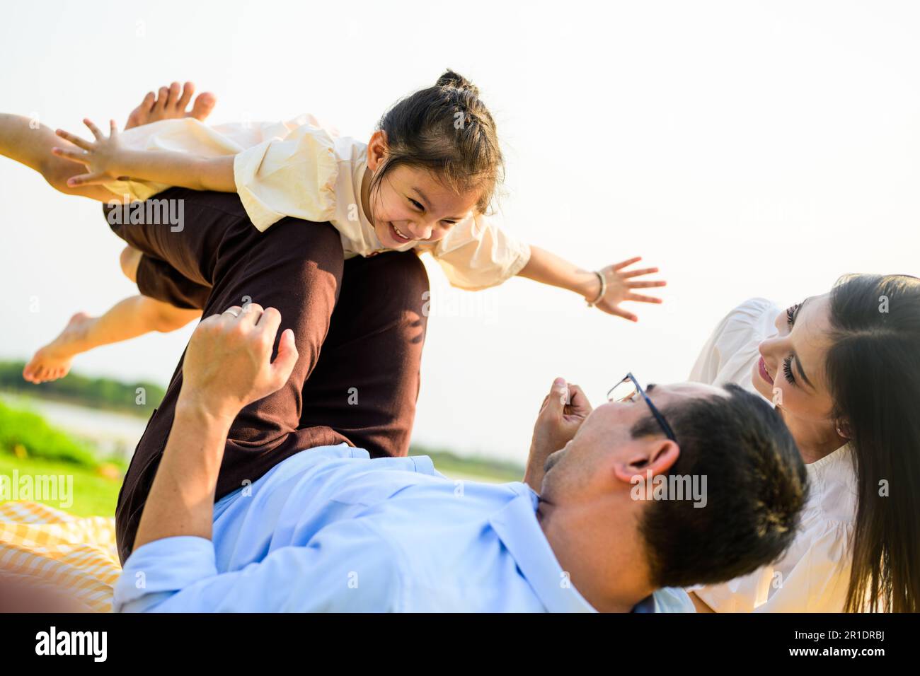 Happy family relaxing and resting in park together on weekend Stock ...