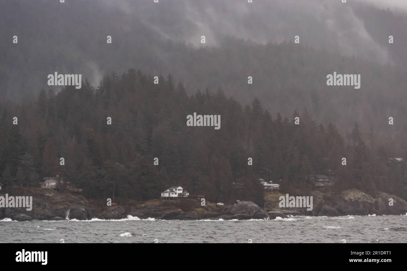 Houses dot the shoreline in the lower mainland of British Columbia ...