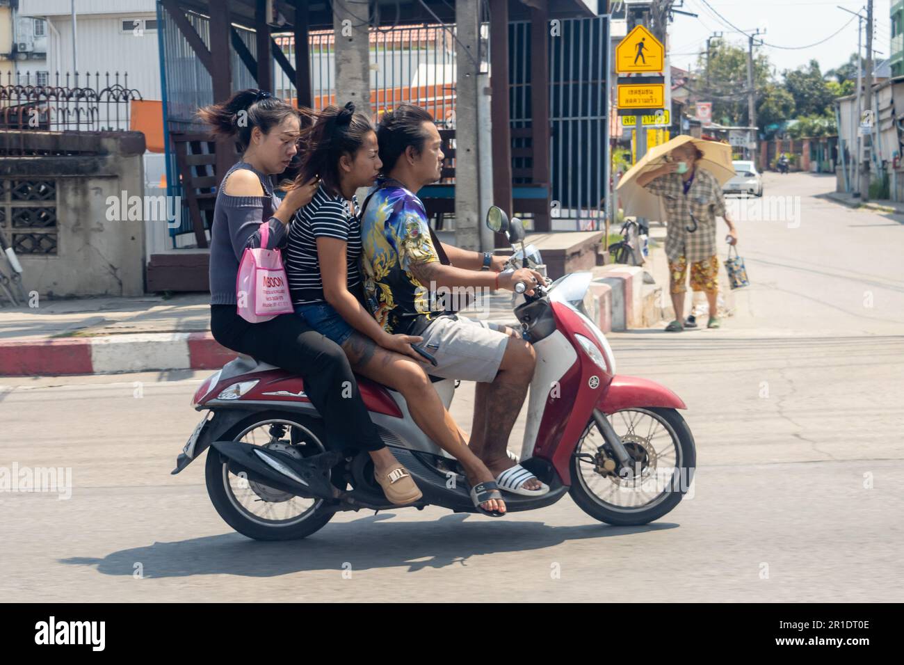 Three people on one motorbike hi-res stock photography and images - Alamy