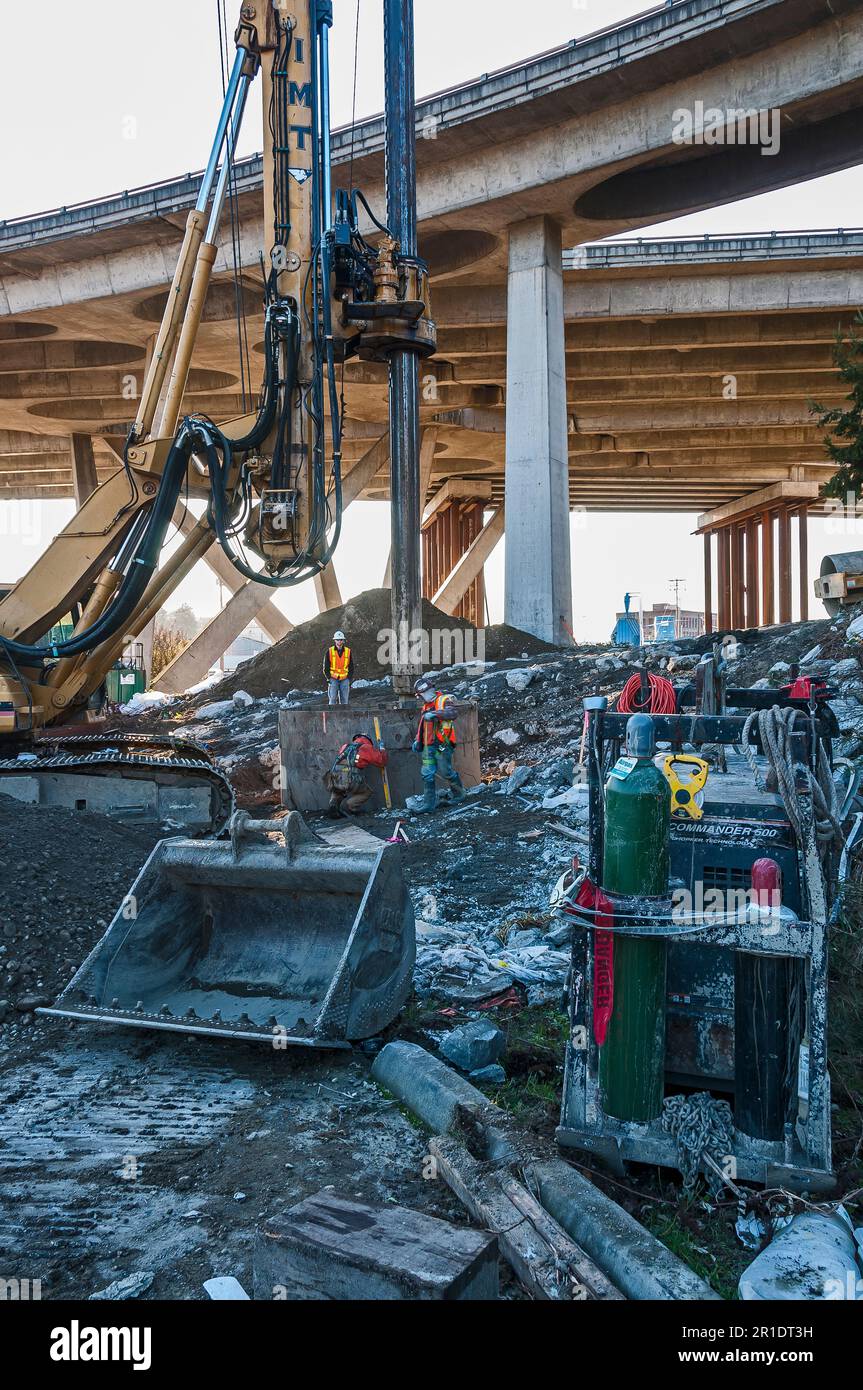 A welding rig and a power shovel attachment in the foreground and a ...