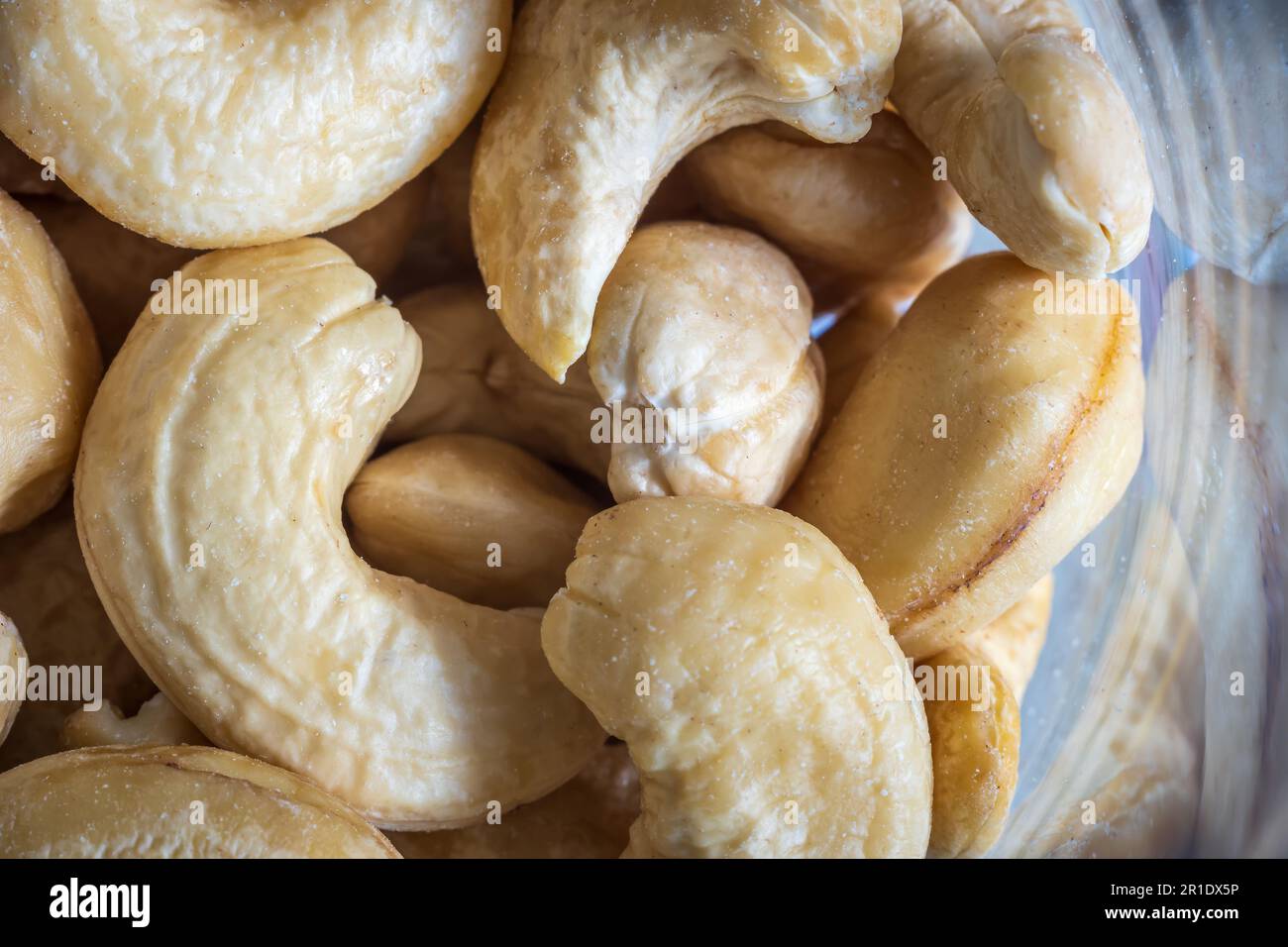 Peeled cashew nuts inside glass jar closeup Stock Photo - Alamy