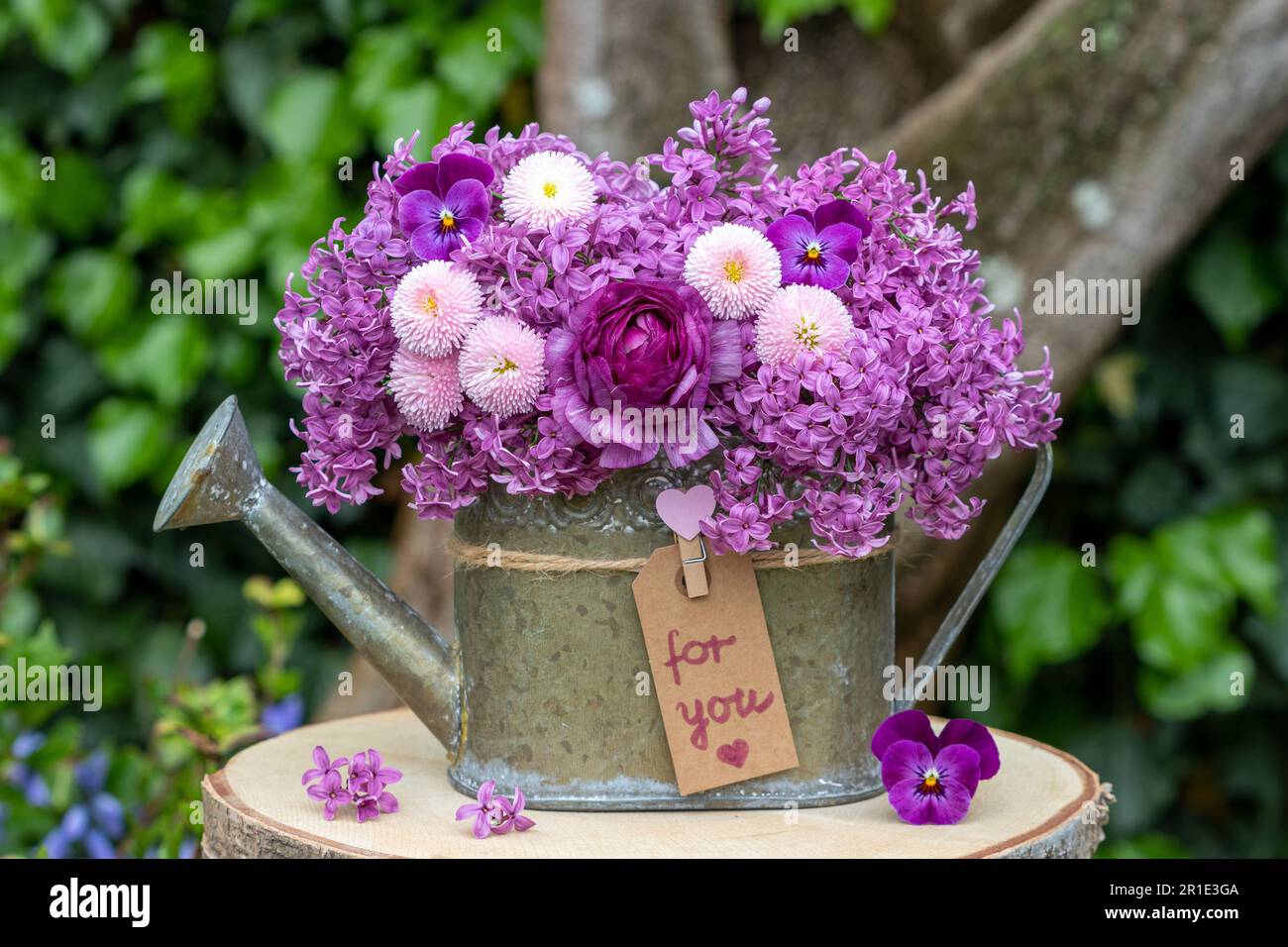 bouquet of purple ranunculus, luilac, bellis and viola flower in ...