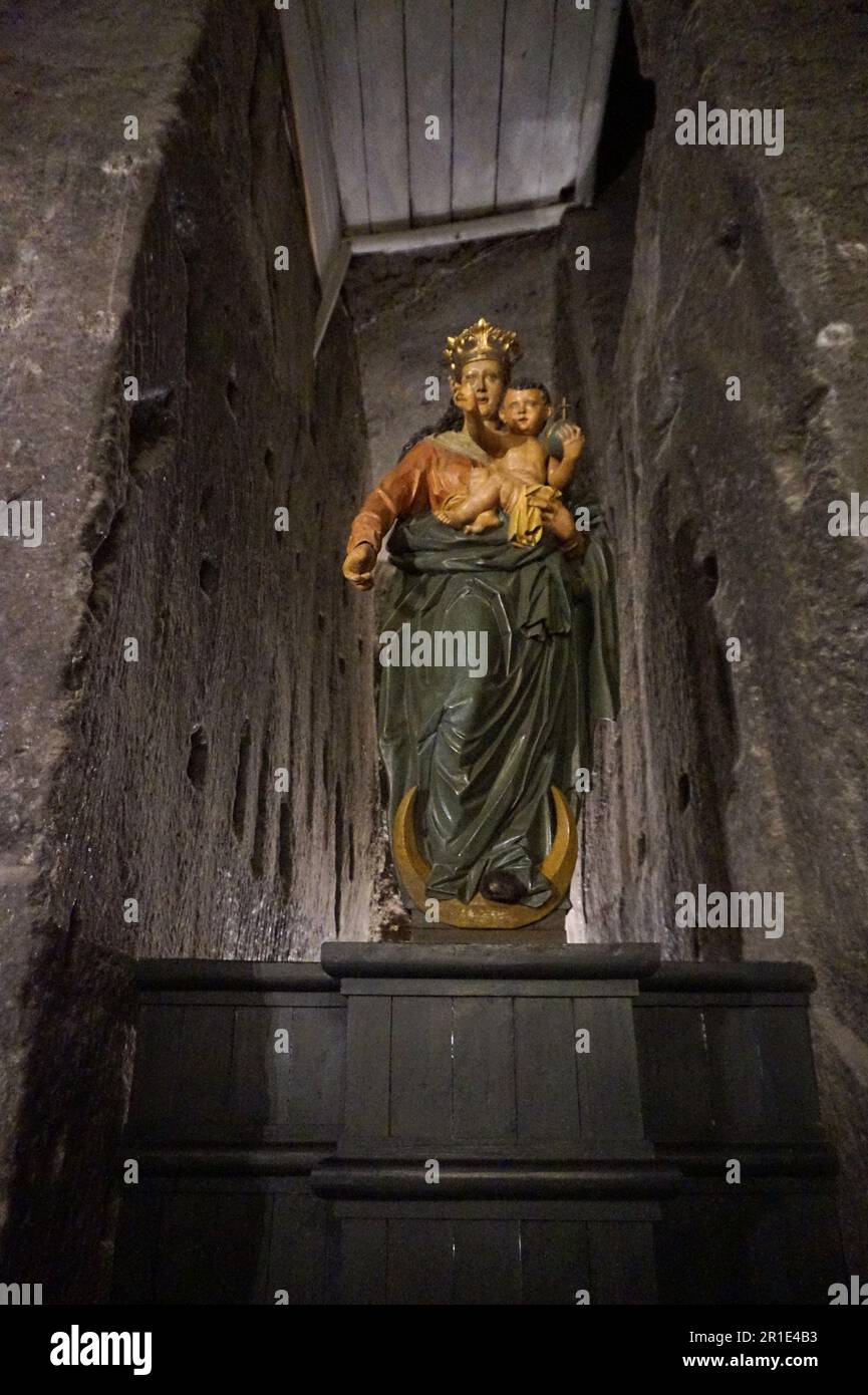 A statue of Mary and the infant Jesus in an undersground church carved ...