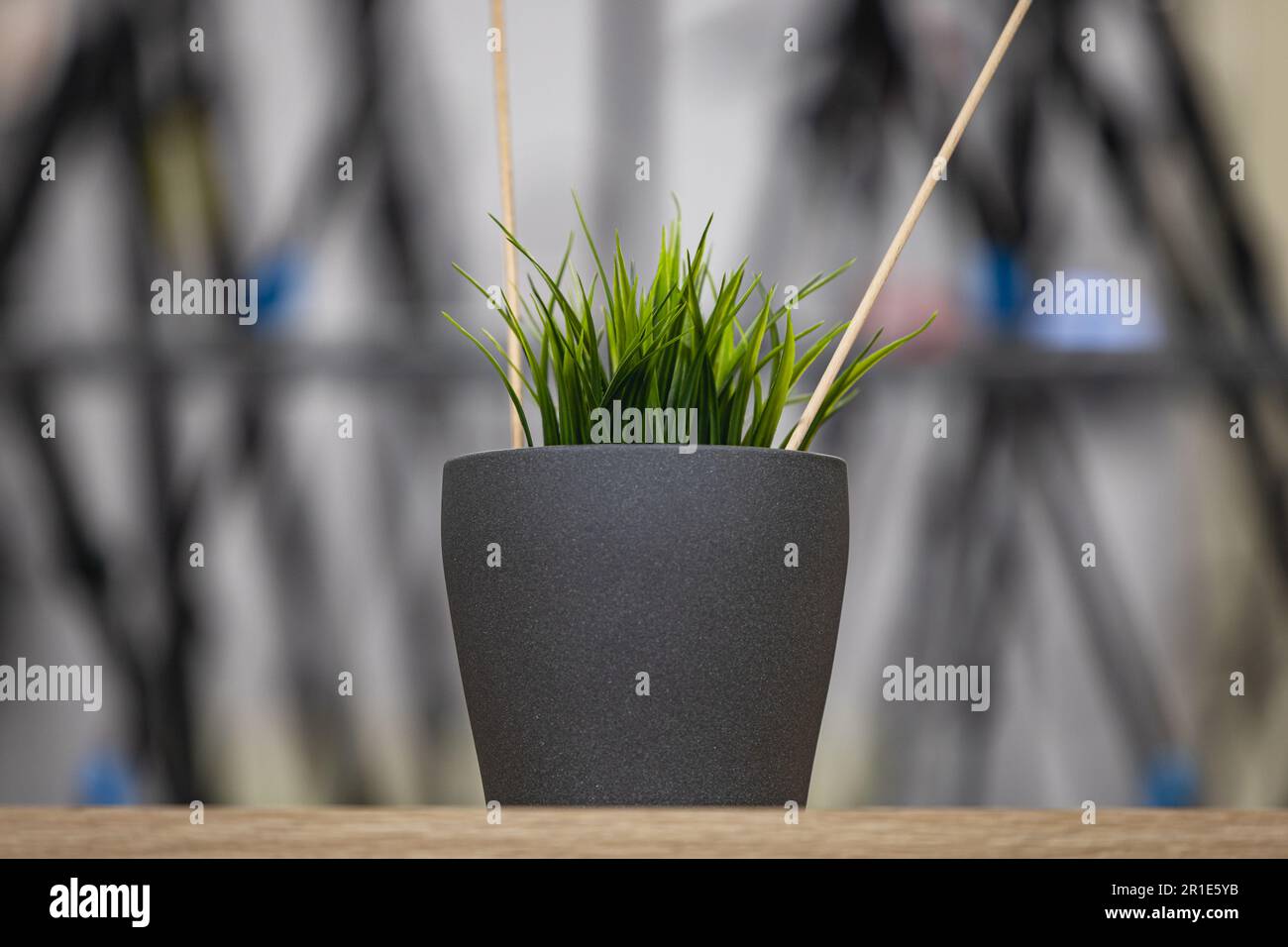 Green artificial grass with a lot of plastic stems in gray concrete ...