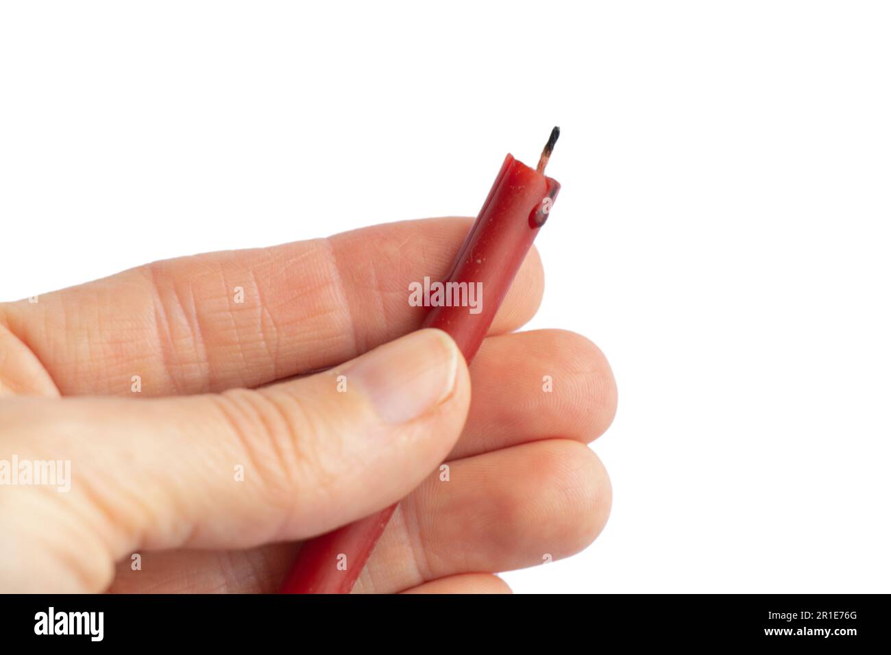 church red wax candle in woman's hand on white background Stock Photo ...
