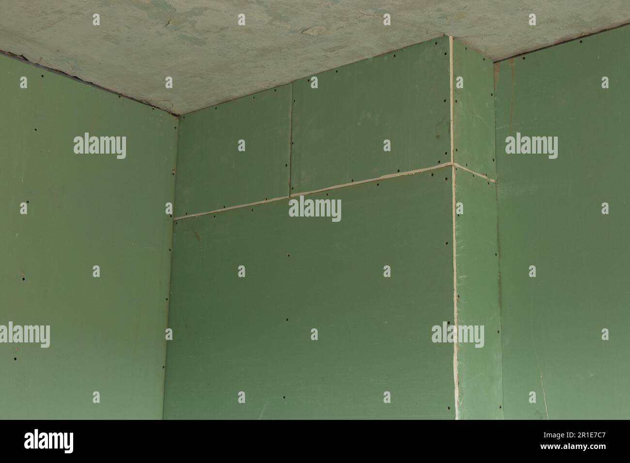 plasterboard green on the wall, room repair Stock Photo - Alamy