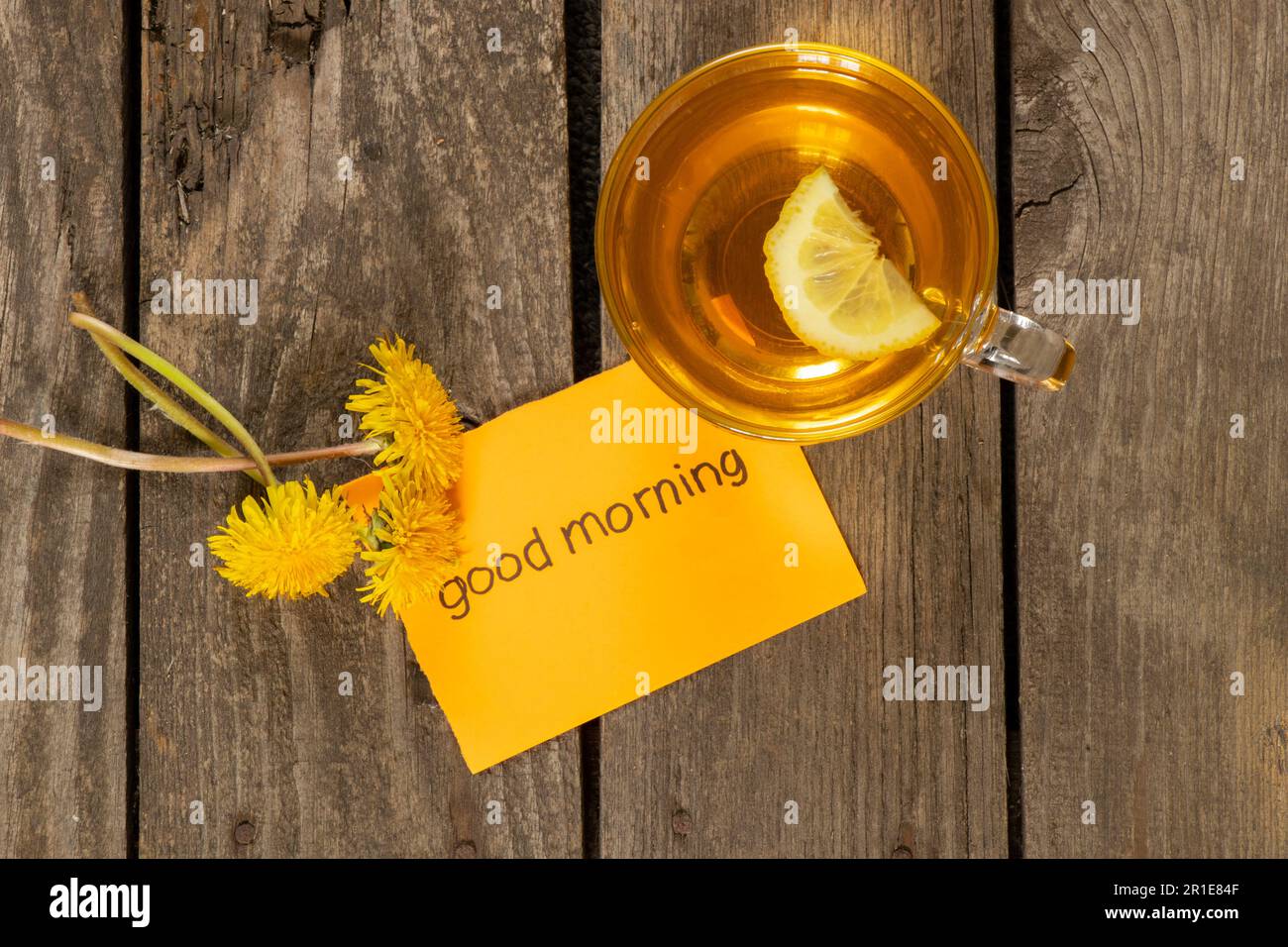a cup of tea with lemon dandelions and the words in English good ...