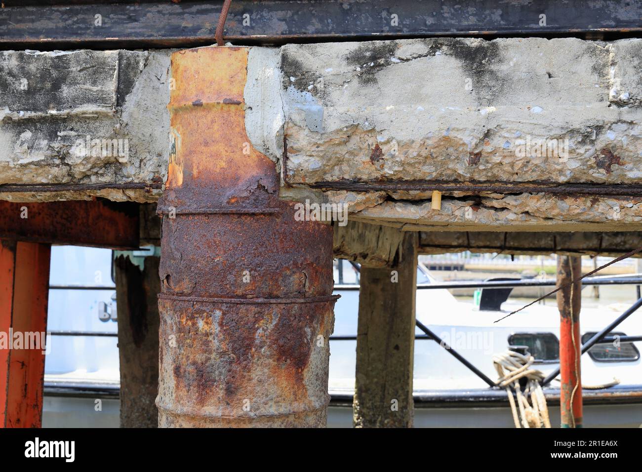 Cracked grey concrete surface with visible reinforcement, Rust in ...