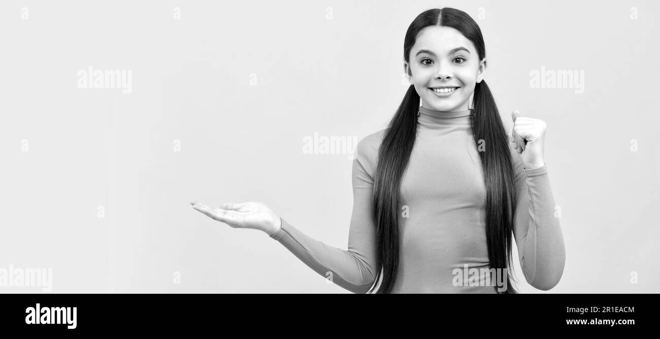 smiling kid presenting product, copy space. pretty teen girl ...