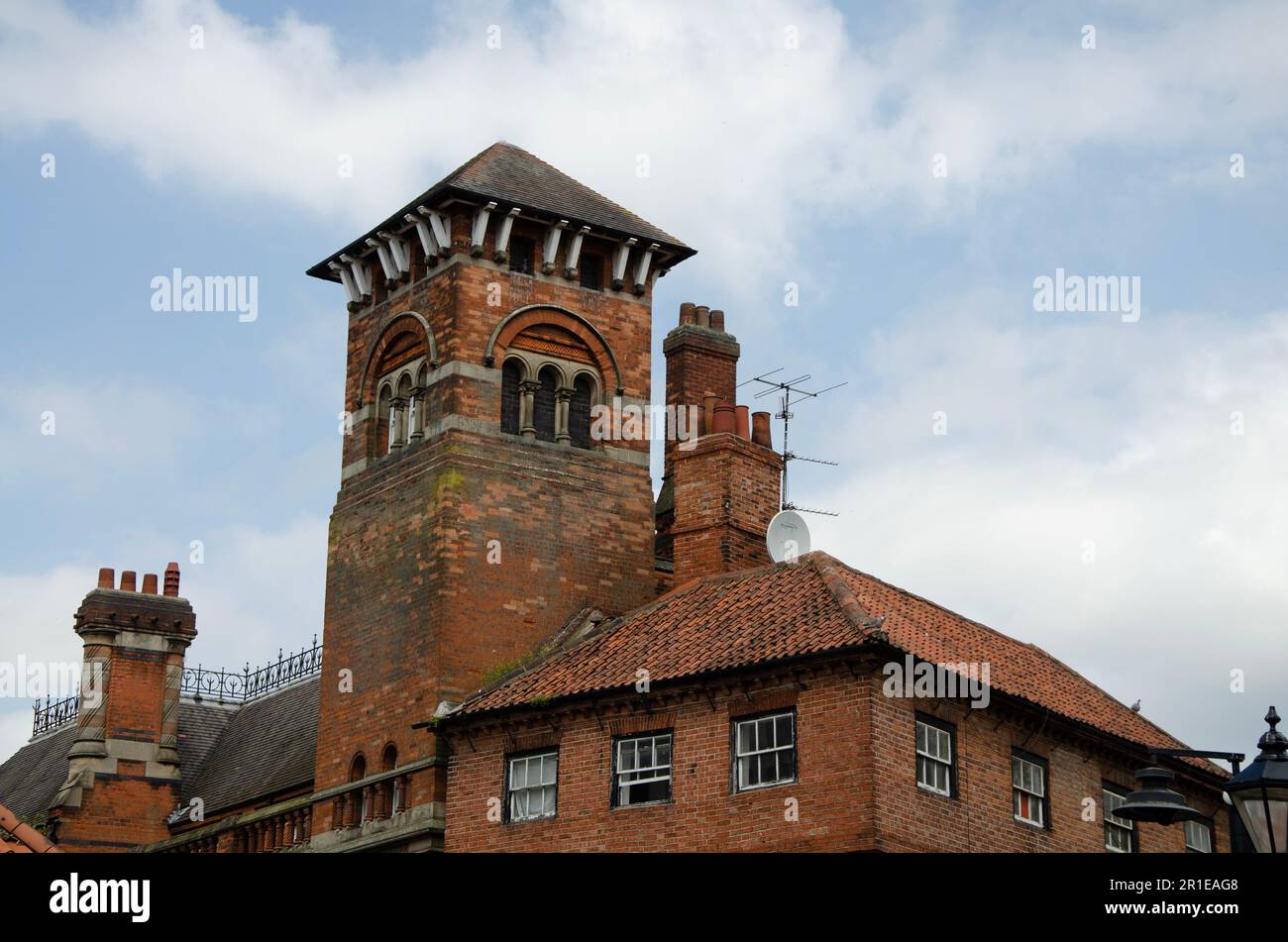 Old red brick building with single turret. Old bank building with tiled ...