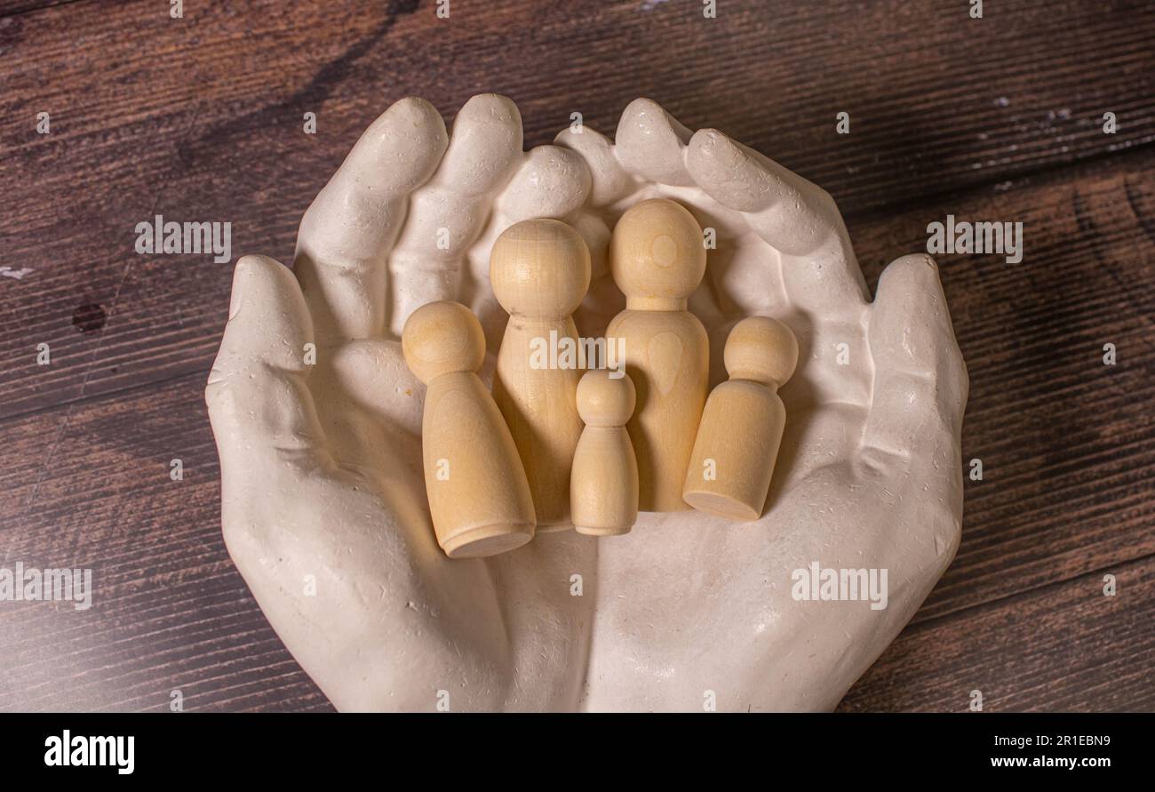Housing for families. Close up of wooden figurines of family with ...