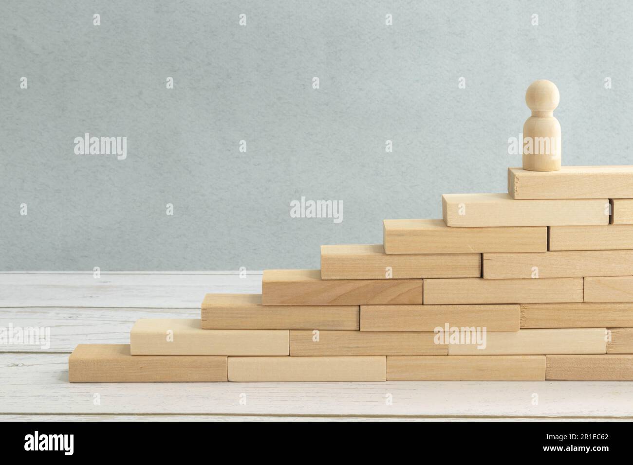 Man is standing next to a ladder, climbing up in career, having a goal ...