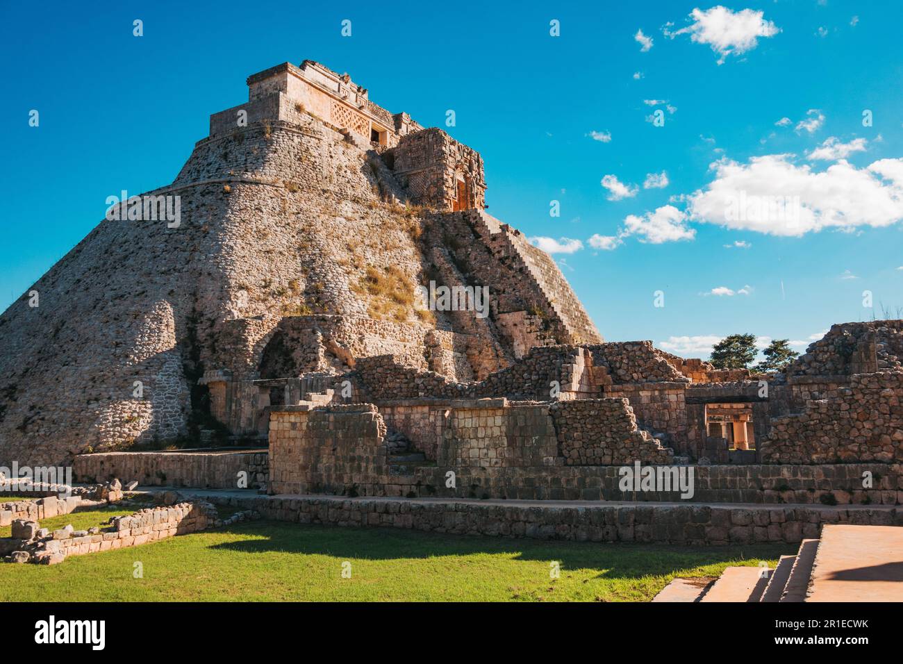 the Pyramid of the Magician towers over the ruins of Uxmal, an ancient ...