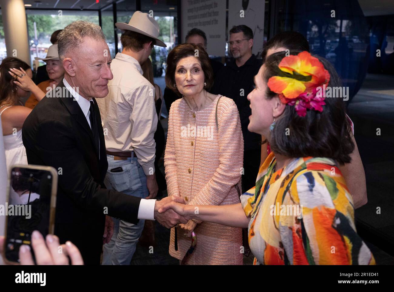 Singer LYLE LOVETT greets guests as LYNDA ROBB looks on at the red ...