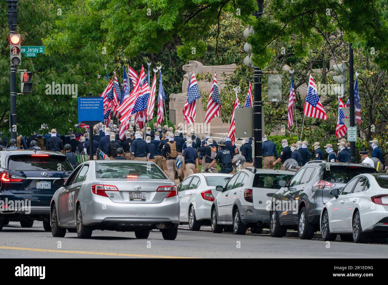 Carrying shields, covering their faces, and holding upside down U.S ...