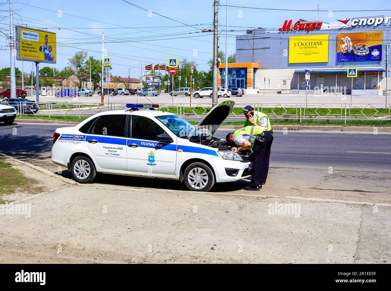 Samara, Russia - May 1, 2023: Police officers repairing the engine of a ...