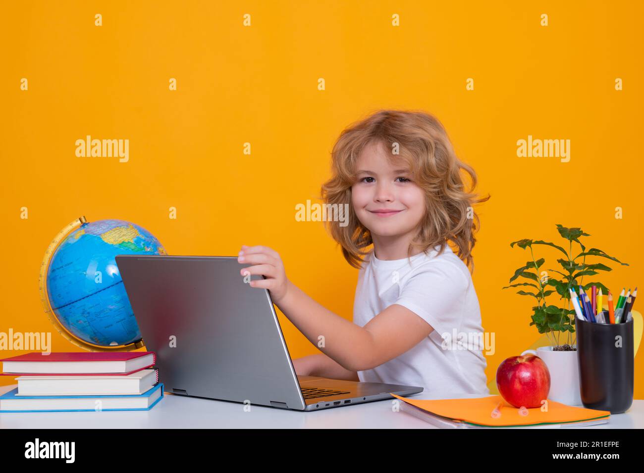 School child portrait isolated on yellow studio background. School ...