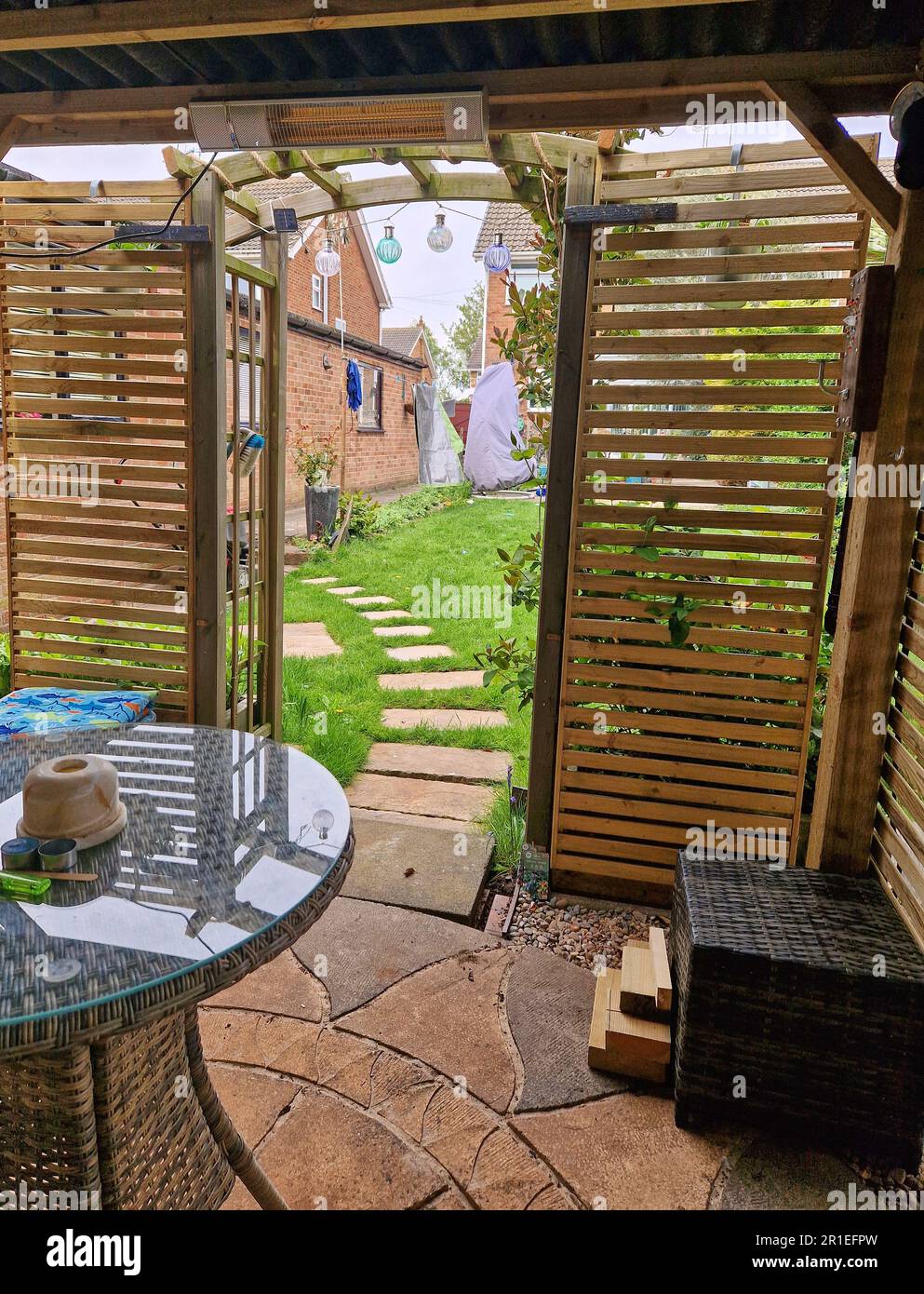 Patio furniture under a wooden gazebo Stock Photo - Alamy