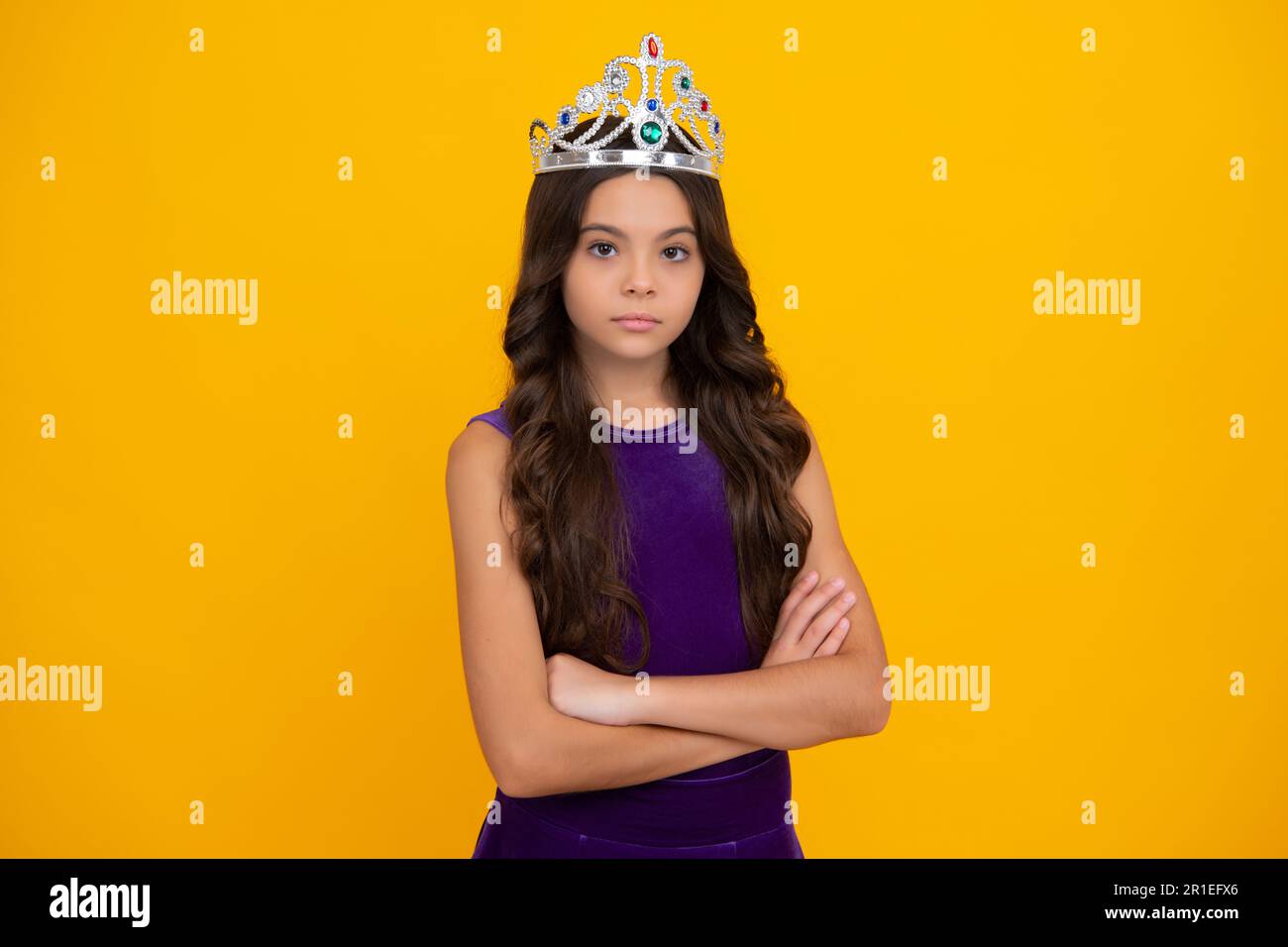Little queen wearing golden crown. Teenage girl princess holding crown ...