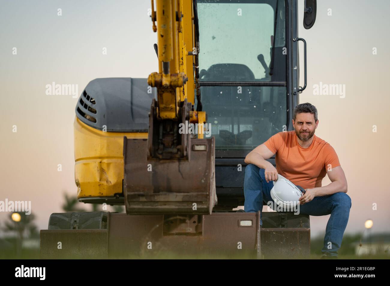Builder with excavator for construction at the construction site ...