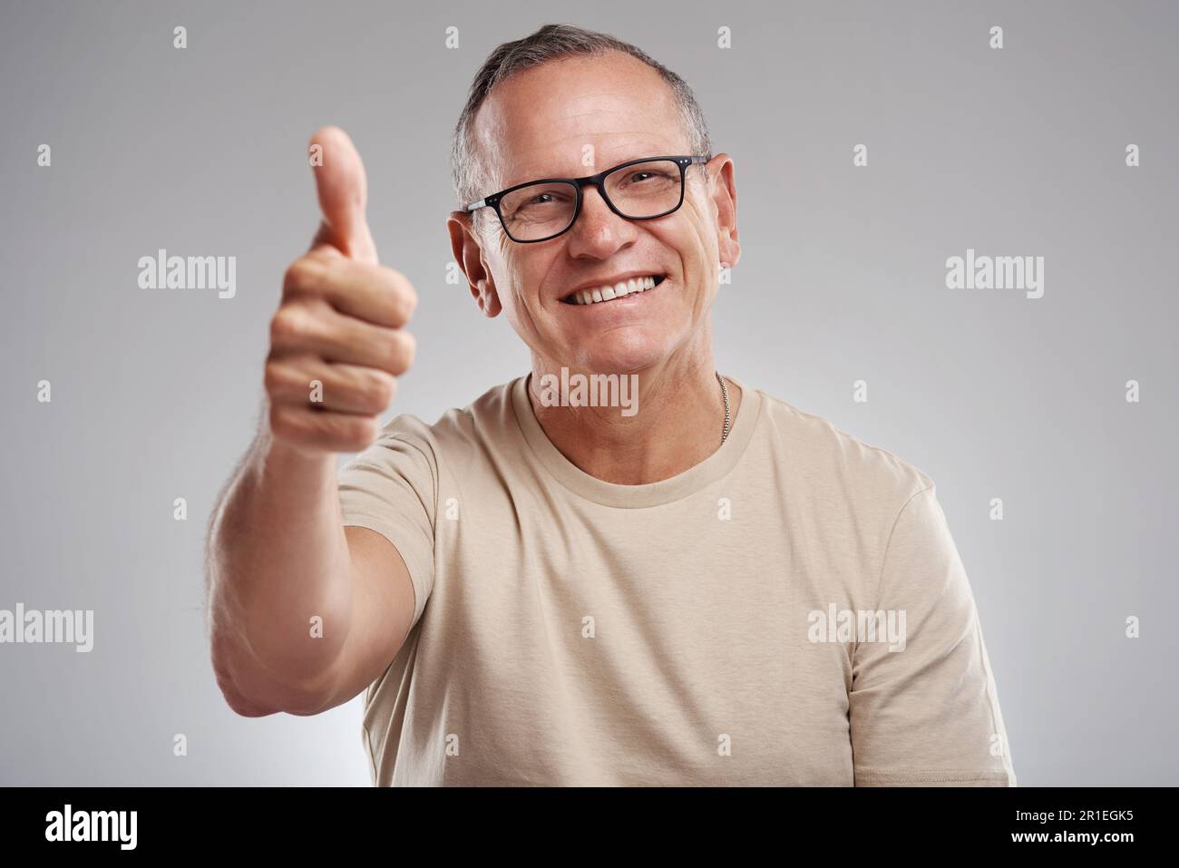 Trust me, its the best. a handsome mature man standing against a grey ...