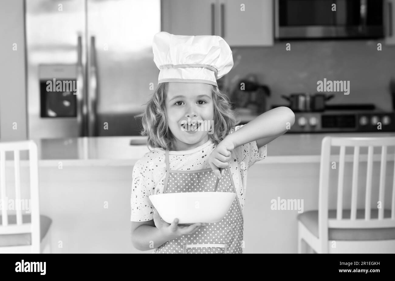 Child chef cook with cooking plate. Fun kids kitchen. Funny little kid ...