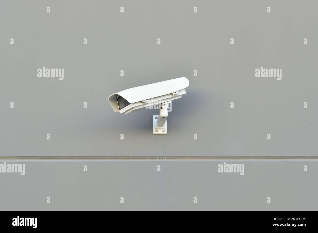 security camera working on the wall of a building Stock Photo - Alamy