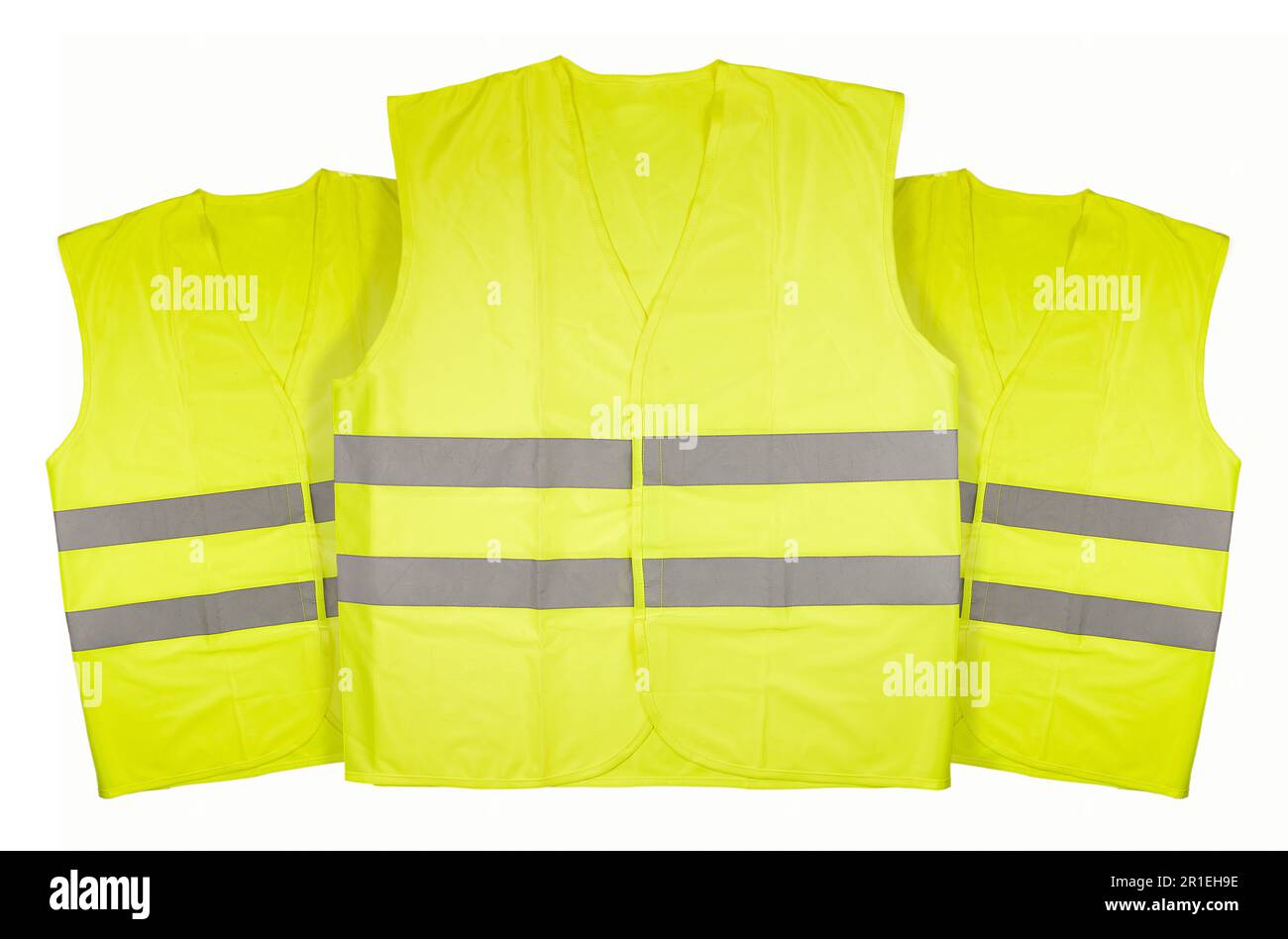 Three yellow vests on white background Stock Photo - Alamy