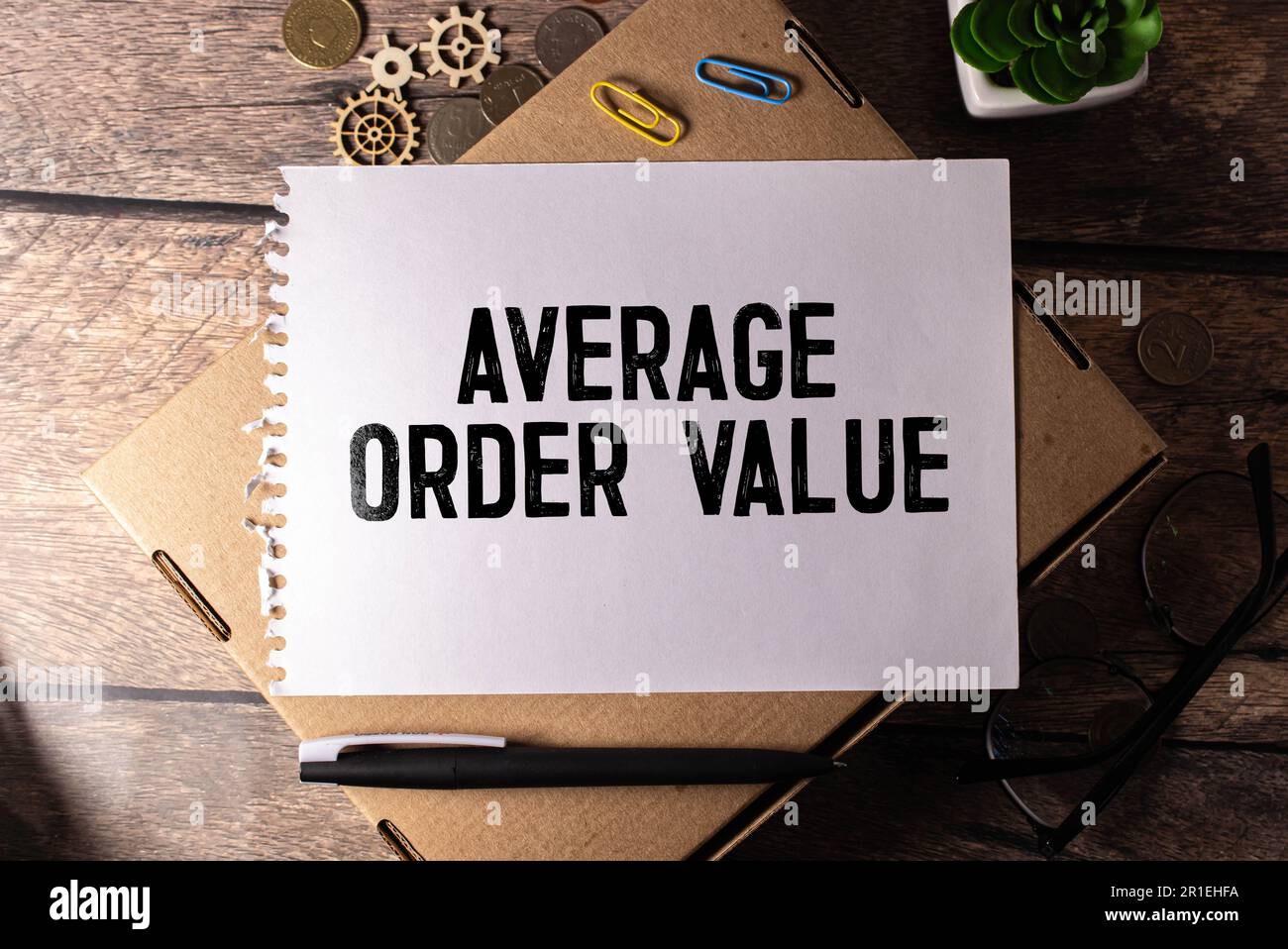 AVERAGE ORDER VALUE. Black marker on torn cardboard background Stock ...