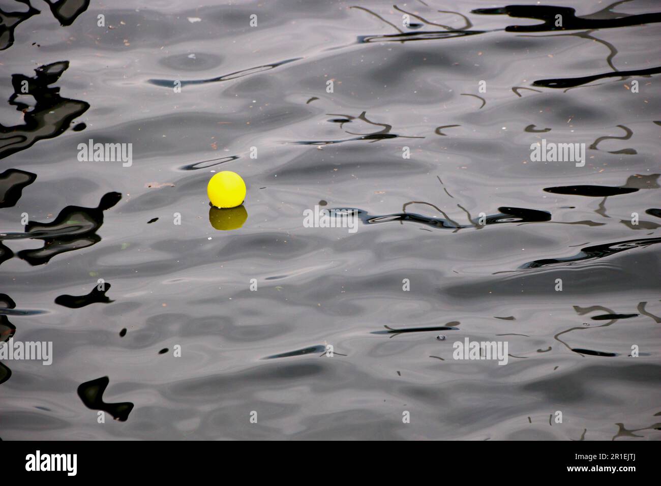 Image of a colorful yellow ball floating on the water, ideal to ...