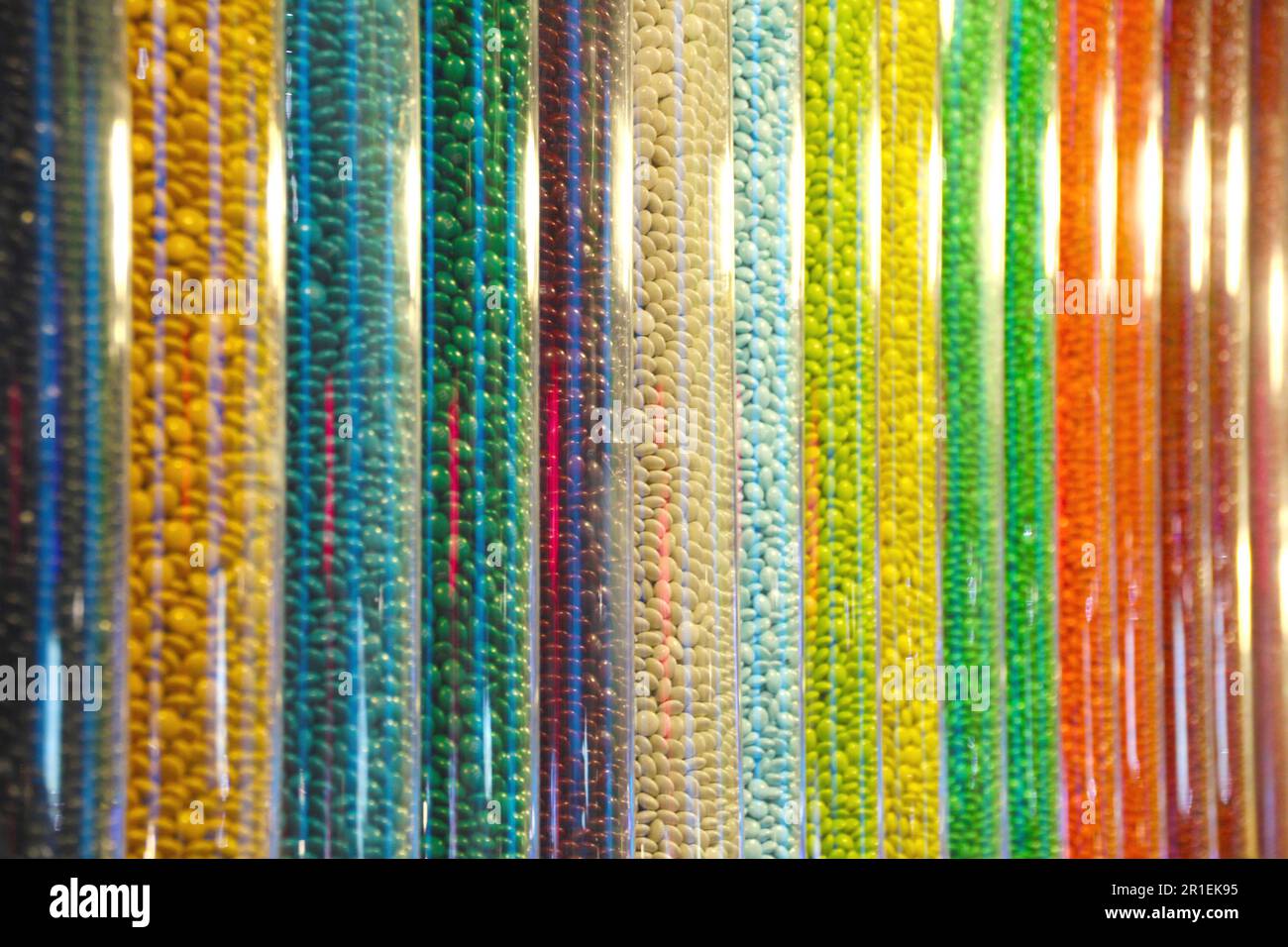 Colorful candies inside shiny cylindrical containers Stock Photo - Alamy
