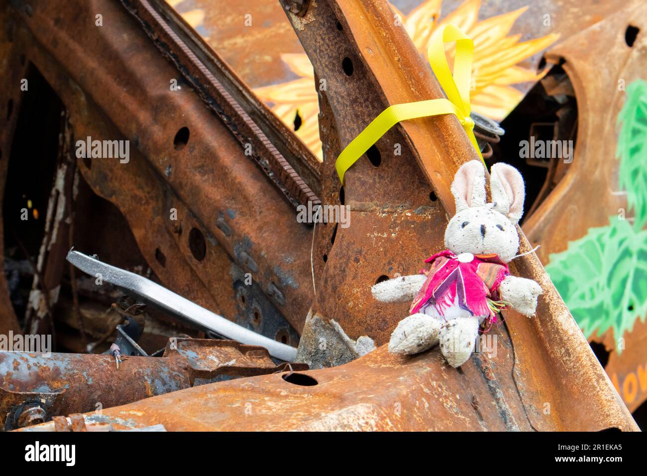 Close-up of a child's toy in ruins after a fire. A soft toy among the ...