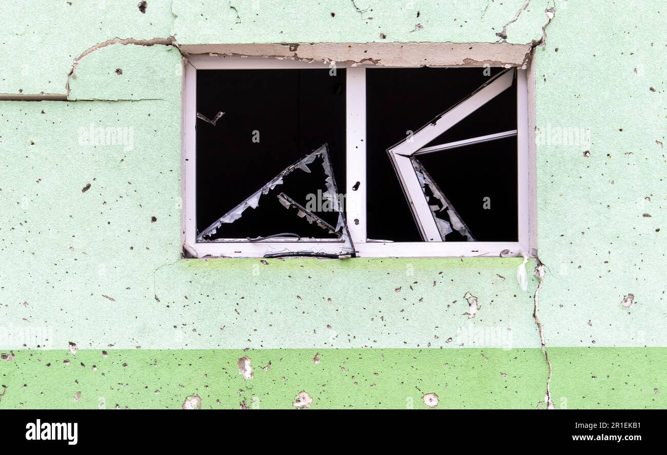 Destroyed and damaged window in the building as a result of the war. The houses were destroyed ...