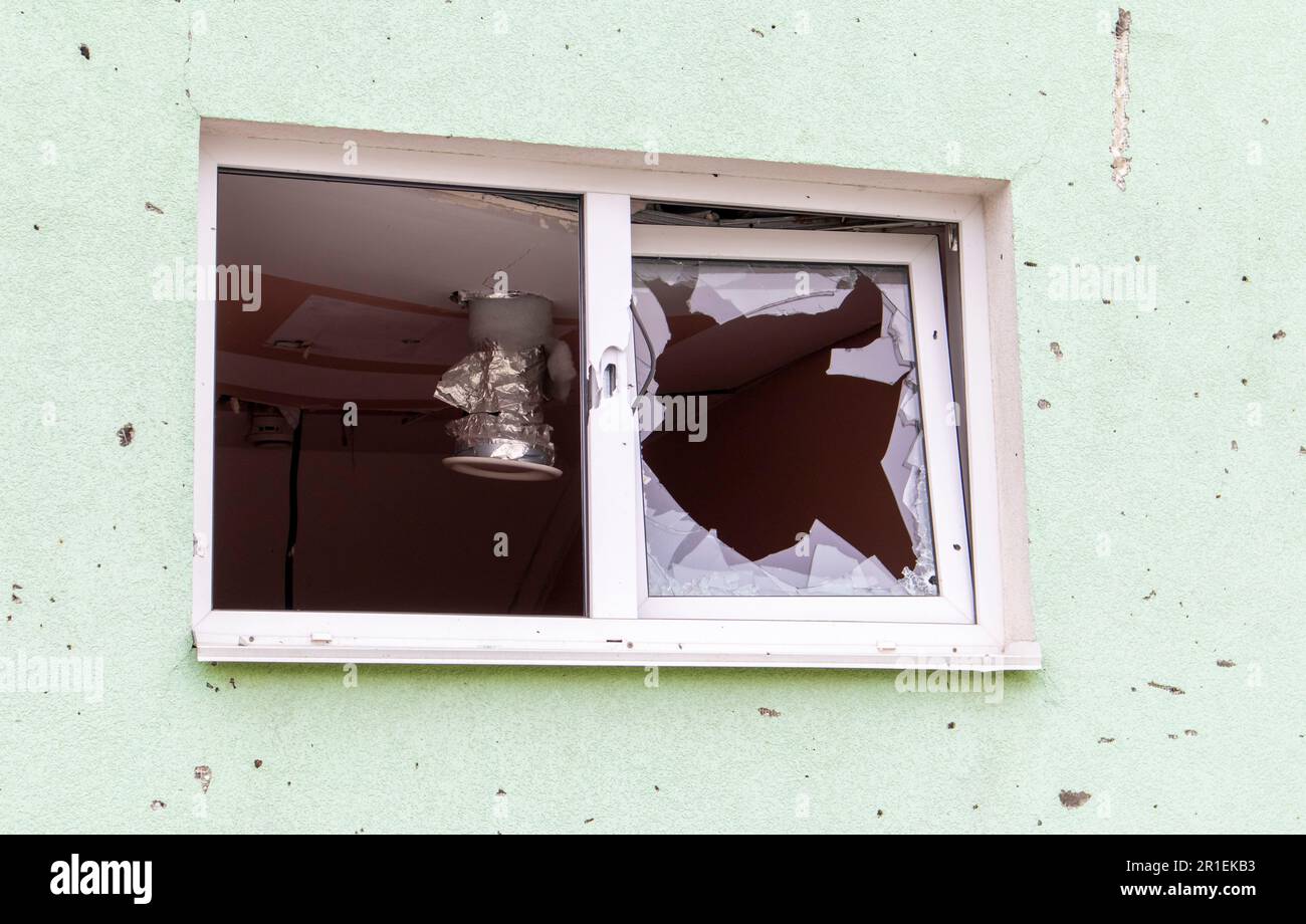 Destroyed and damaged window in the building as a result of the war. The houses were destroyed ...