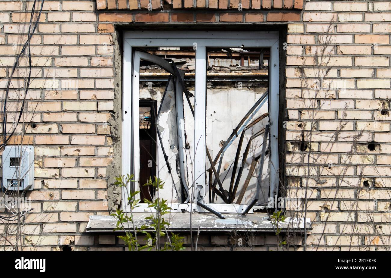 The buildings were hit by shelling. One window and damaged brick facade ...