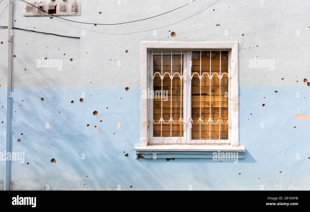 The buildings were hit by shelling. Boarded up windows and damaged ...