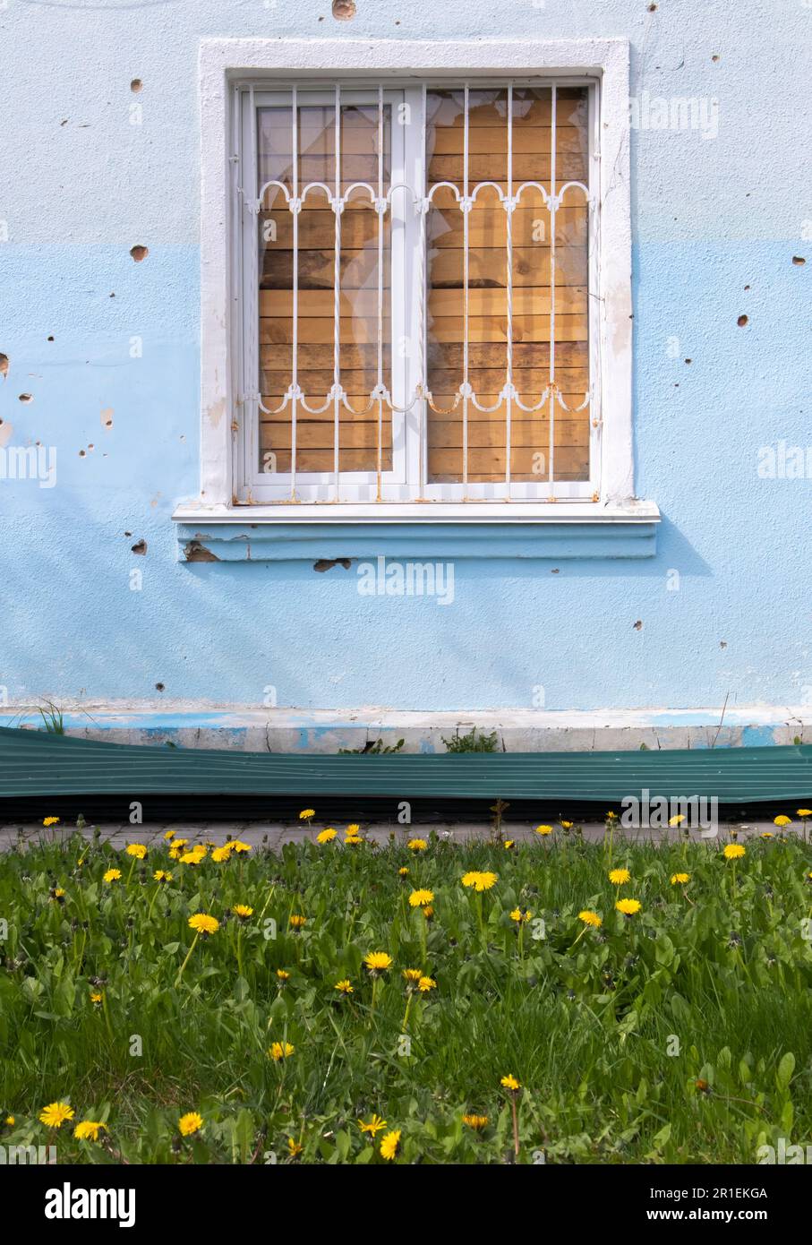 The buildings were hit by shelling. Boarded up windows and damaged ...