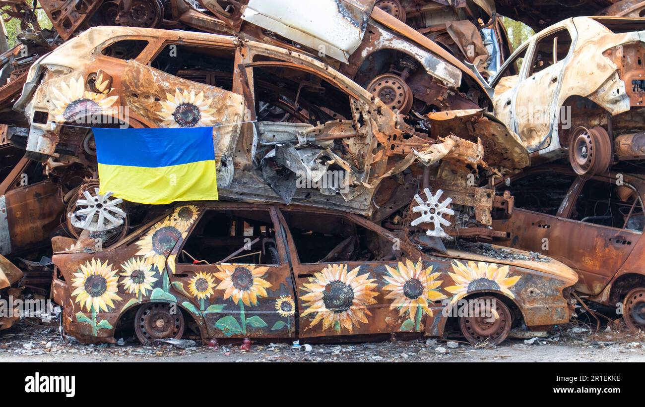 The national flag of Ukraine against the background of ruins and rusty ...