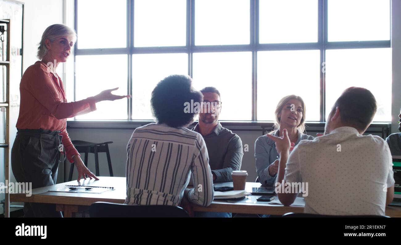 Clear communication keeps a meeting on track. a group of businesspeople ...