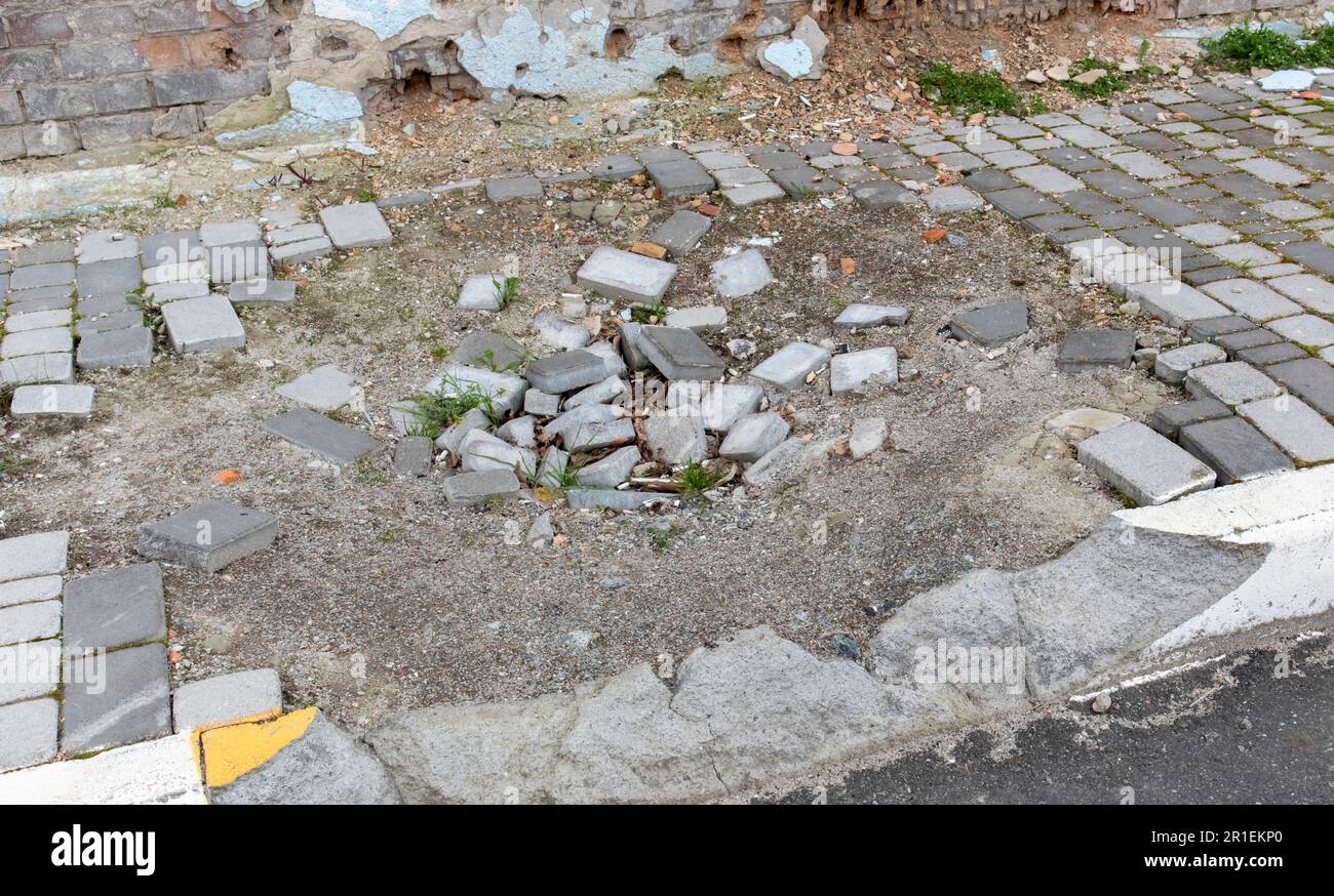 War in Ukraine. Funnel from the explosion in the asphalt. The trace ...