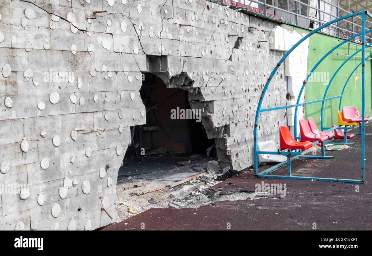 War in Ukraine. Broken plastic benches for fans on the podium, in a ...