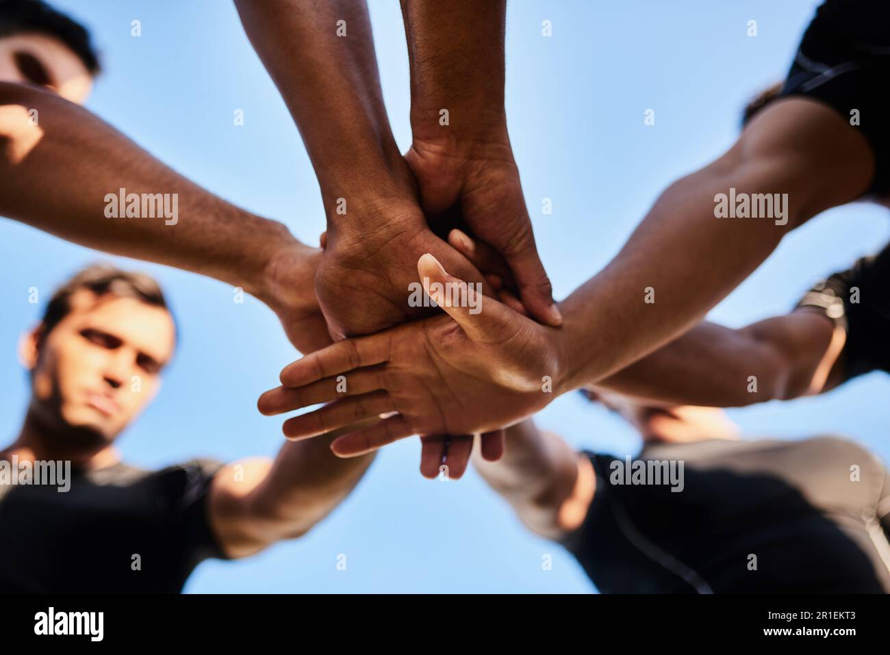 Lets go team. a handsome group of sportsmen huddled together with their ...