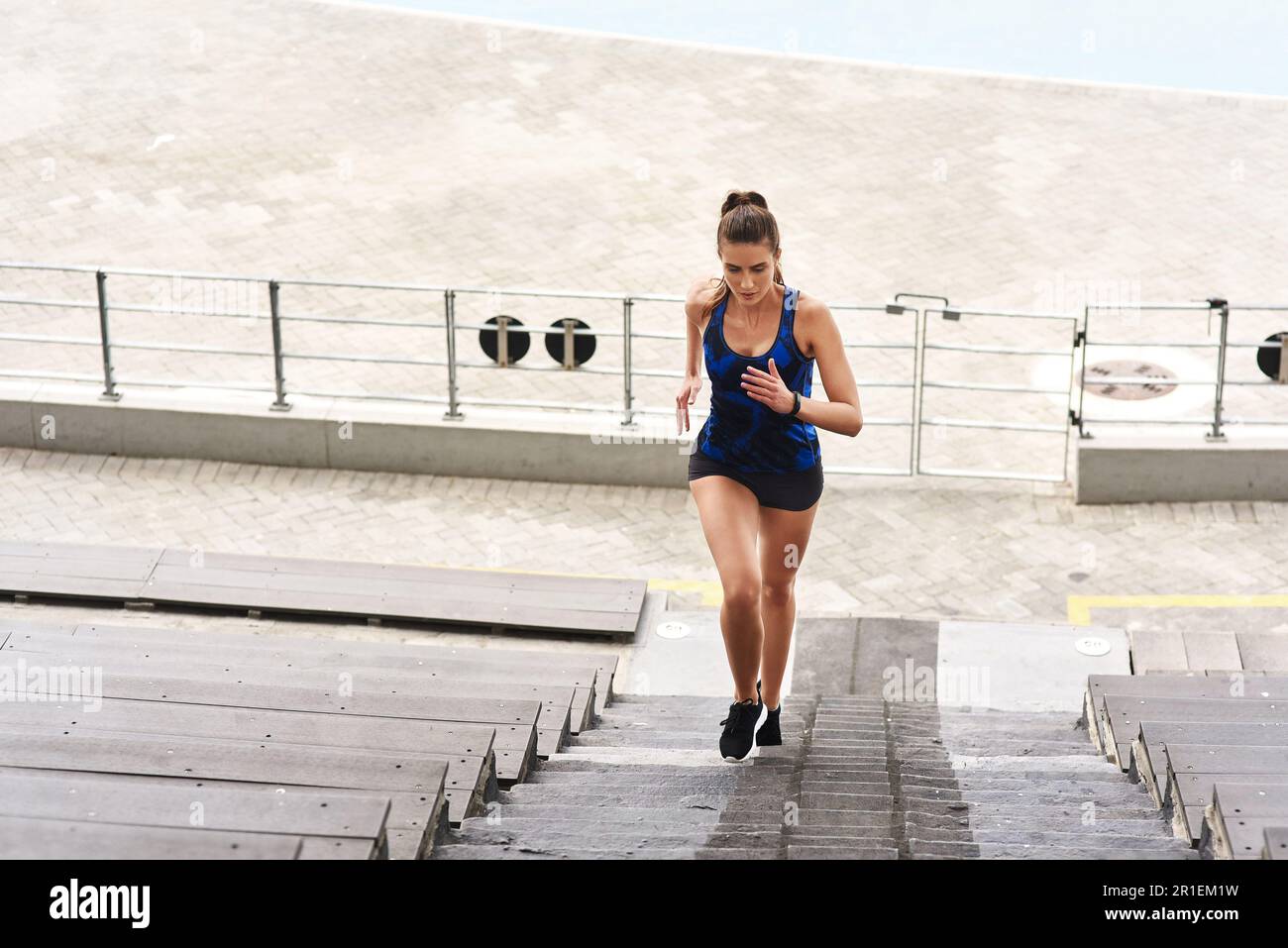 Headed for the top. Full length shot of an attractive young female athlete working out on a ...